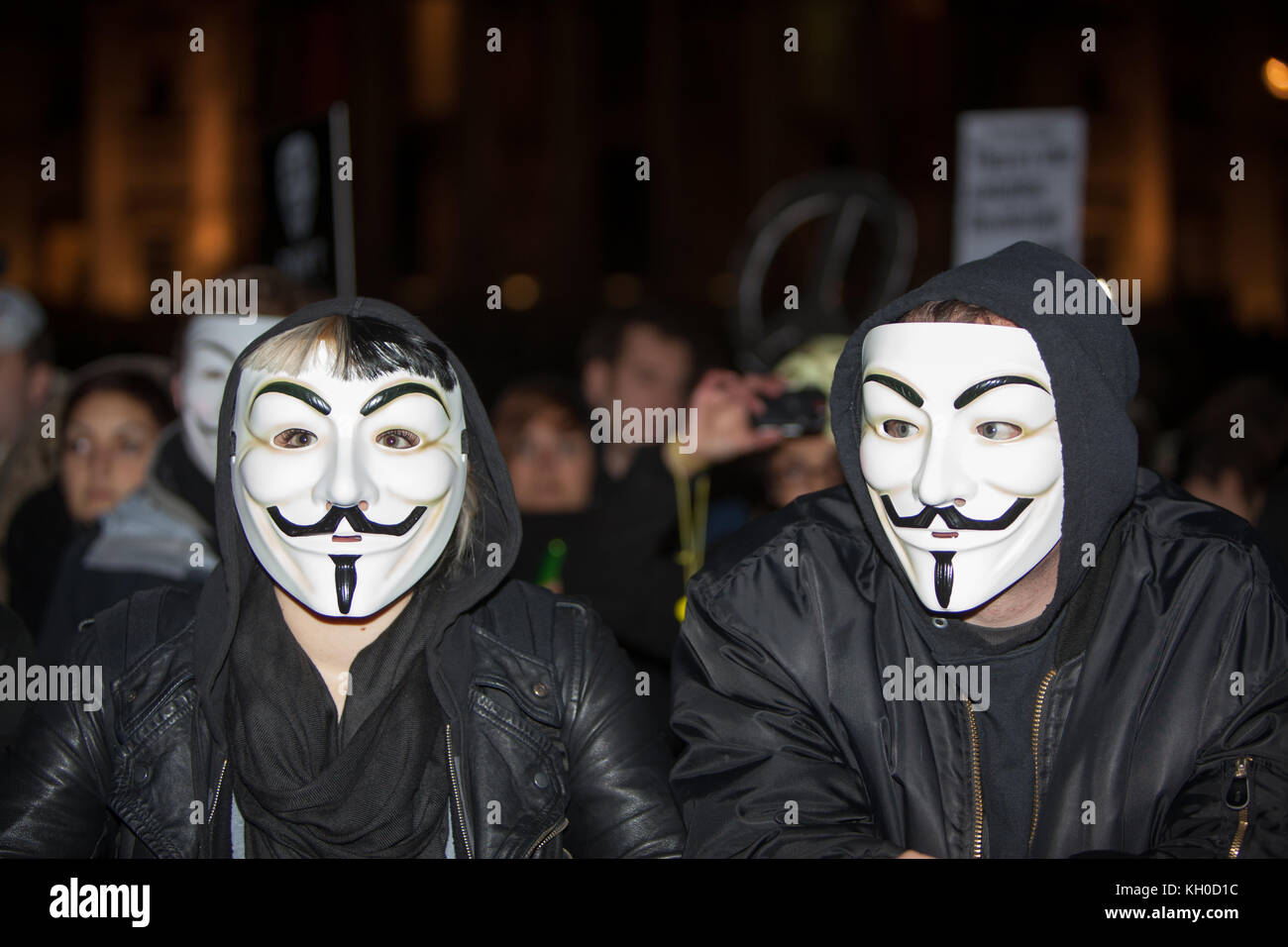 Protesters wear the characteristic Guy Fawkes mask, which has become a ...
