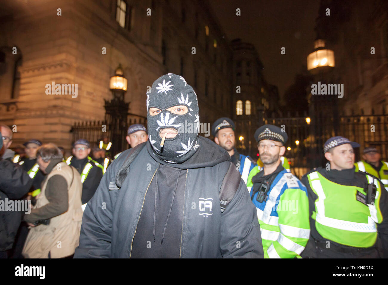 A Million Mask March activist wears a balaclava and smokes a joint in ...