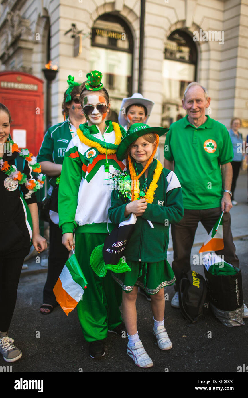 A group of Saint Patrick’s Day participants are dressed in green and ...