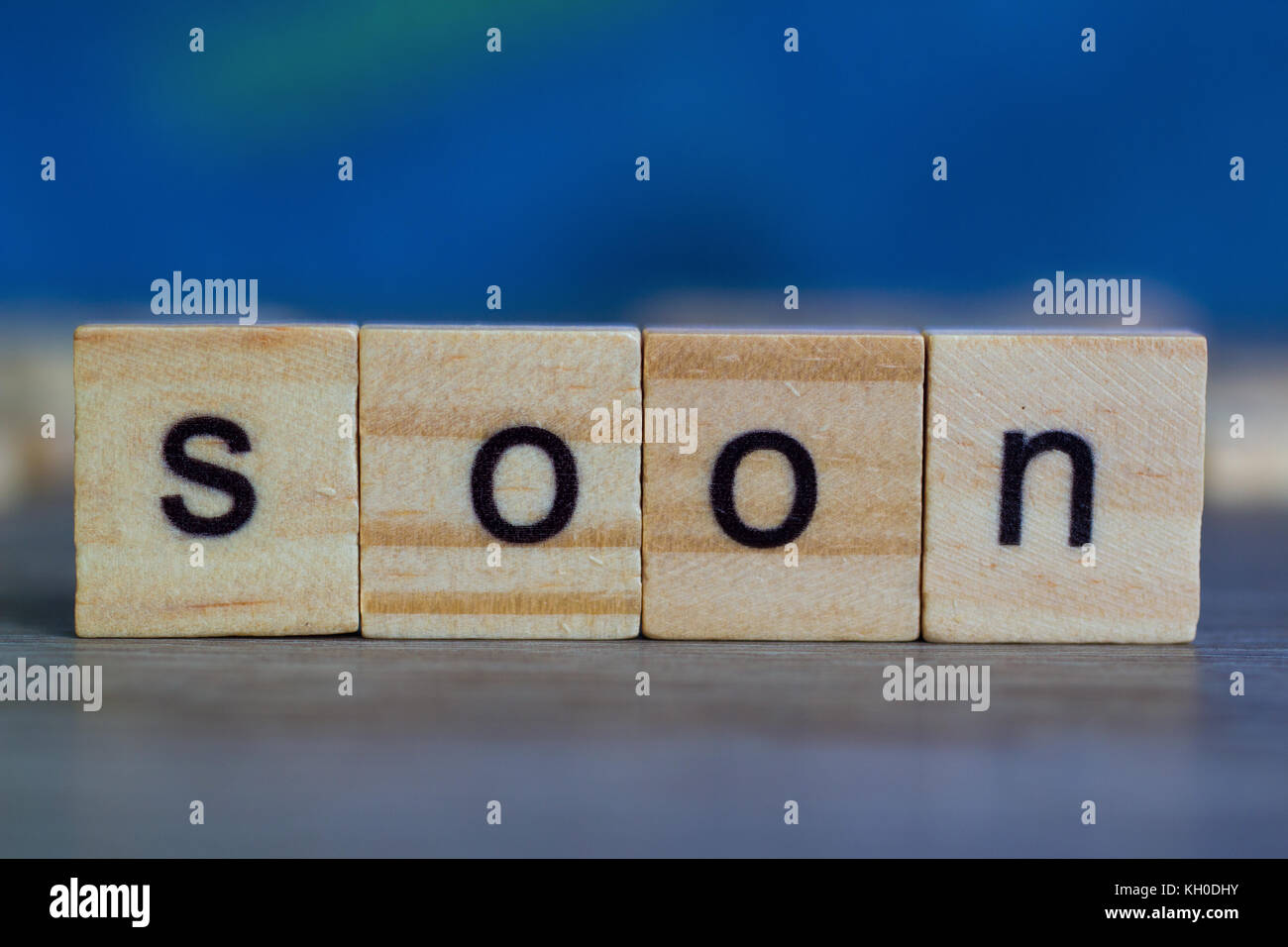 SOON word on wood cubes on table against blue background Stock Photo ...