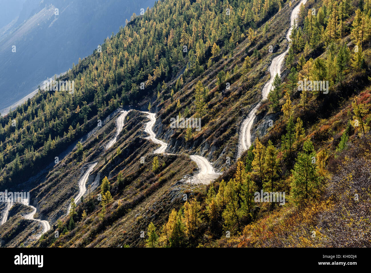 The picturesque top view on the steep winding gravel road through the ...