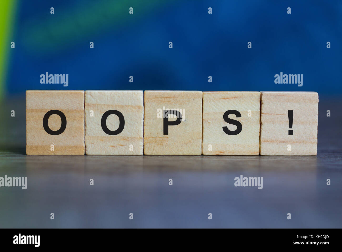 OOPS word on wood cubes on table against blue background Stock Photo ...