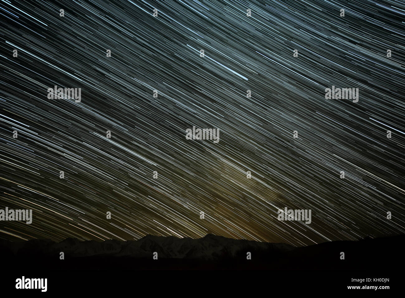 Beautiful night view of the starry sky with traces of stars in the form ...