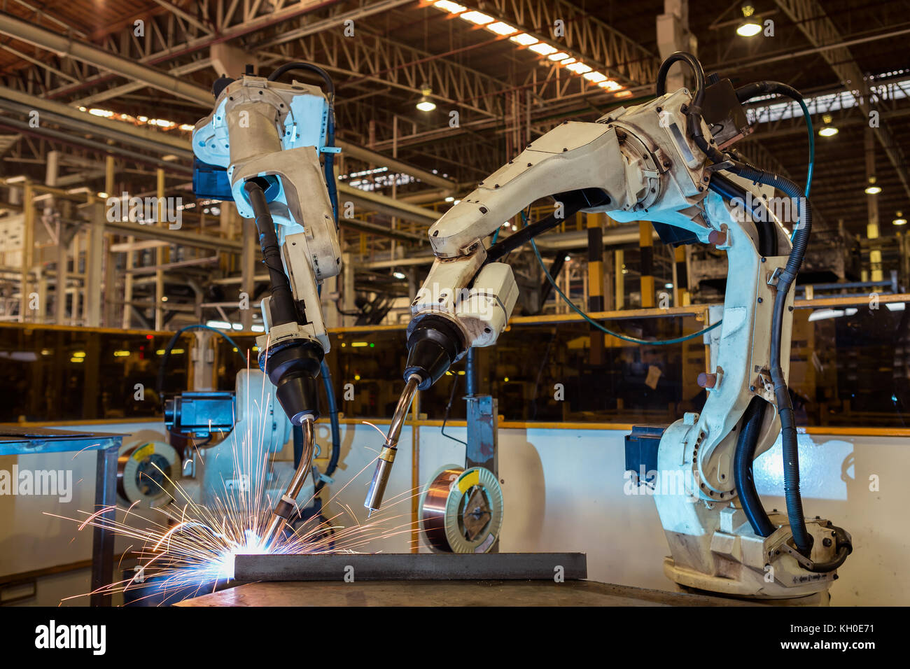 Industrial robot welding metal part Stock Photo - Alamy