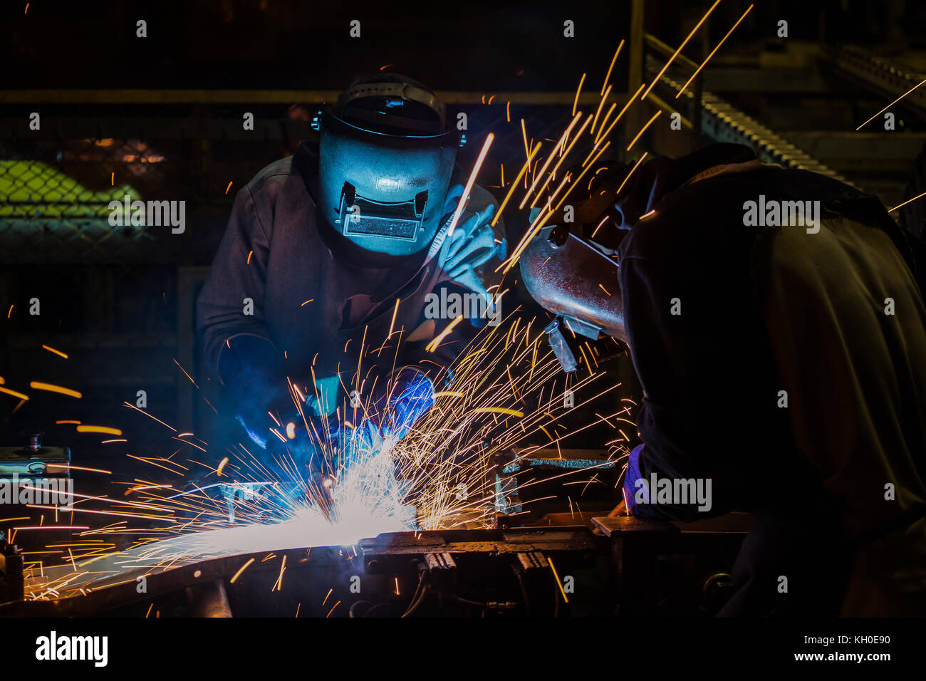 Industrial worker is welding in factory Stock Photo - Alamy