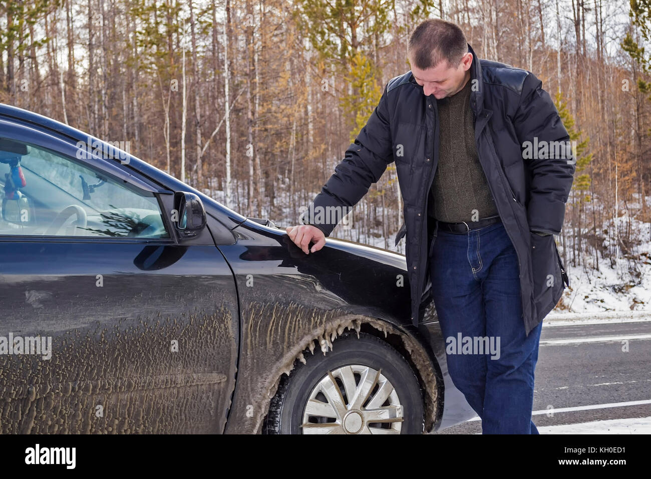 The driver looks at the car,covered with ice in cold weather Stock ...