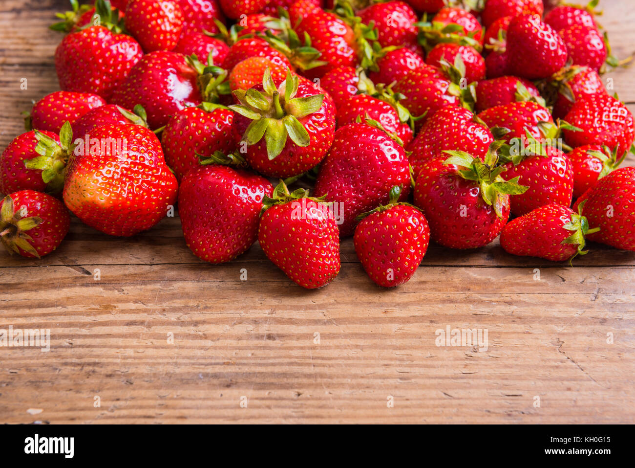 Fresh red strawberry on wood background Stock Photo - Alamy