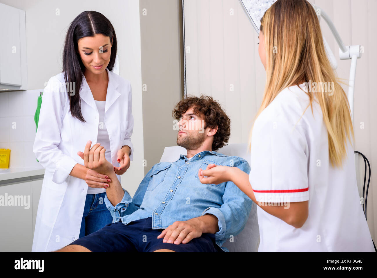 A young male patient in the emergency room with doctor and a nurse ...