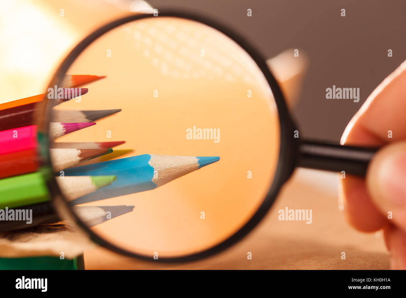 magnifier glass on a color pencils Stock Photo - Alamy