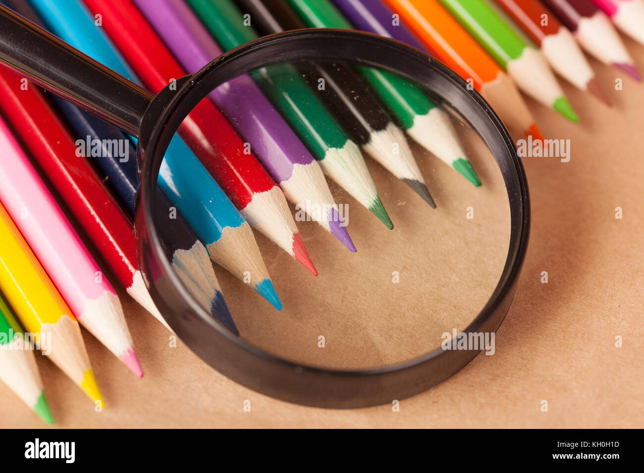 magnifier glass on a color pencils Stock Photo - Alamy