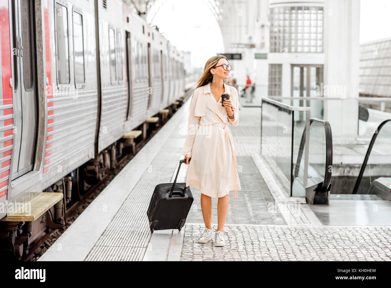 Woman at the railway station Stock Photo - Alamy