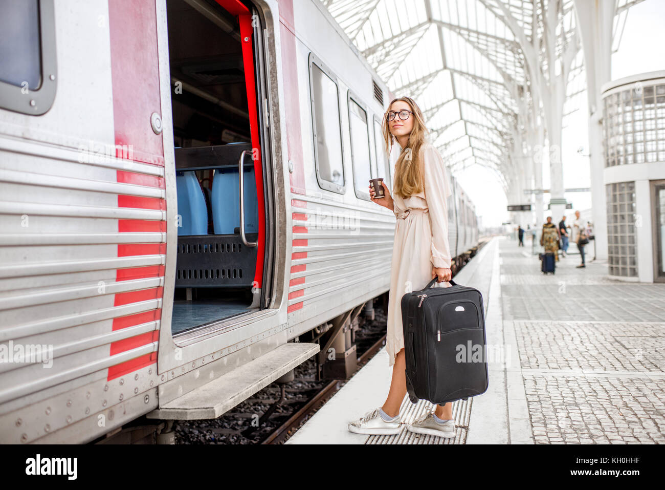 Woman at the railway station Stock Photo - Alamy