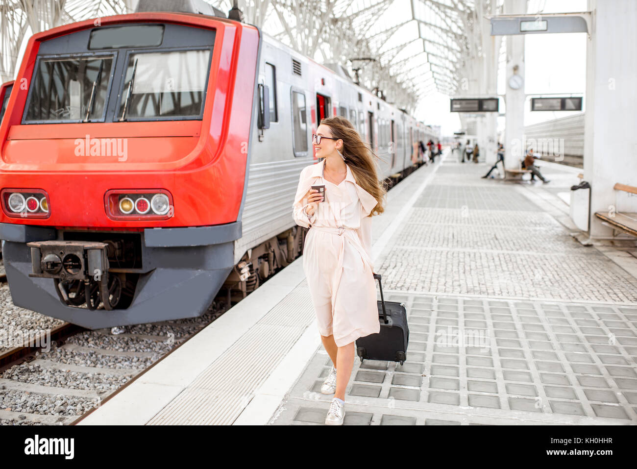 Woman at the railway station Stock Photo - Alamy