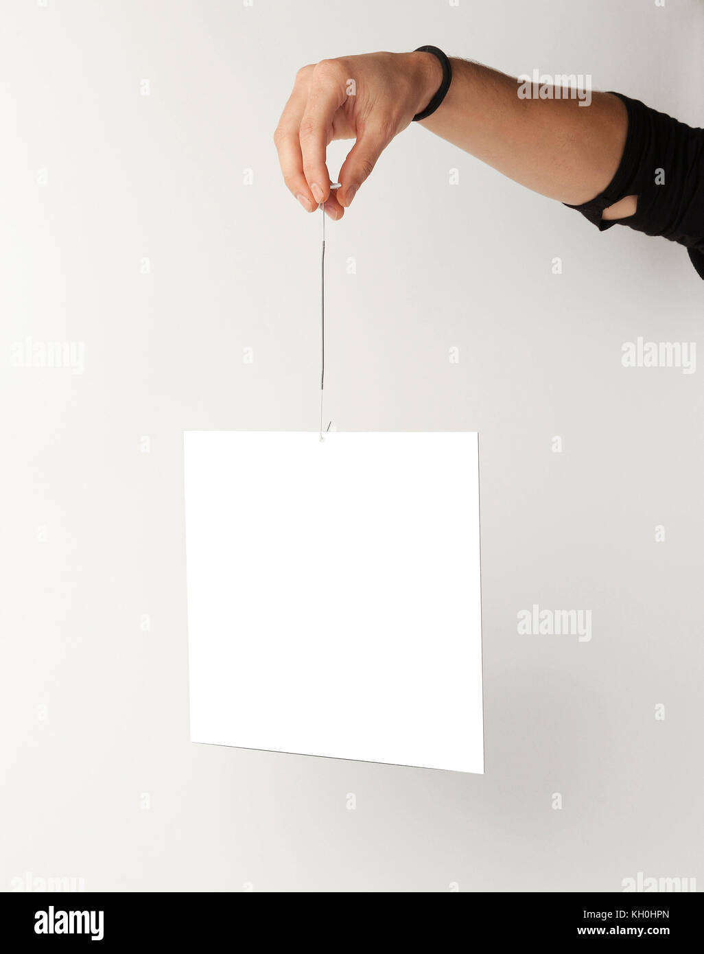 hand holding a white banner Stock Photo - Alamy