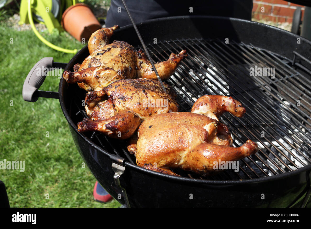 Chicken cooking on a barbecue Stock Photo - Alamy