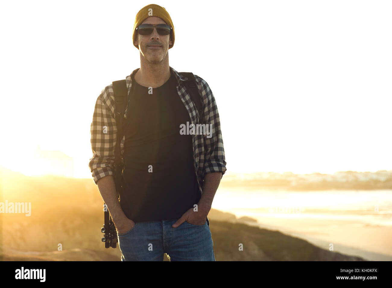Man in outdoor at sunset with the beach on background Stock Photo - Alamy