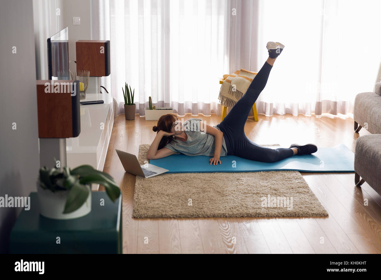 Full length shot of a woman doing exercise at home Stock Photo - Alamy