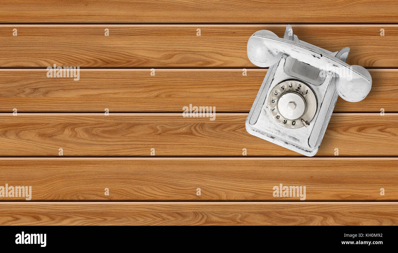 Peel white vintage phone on a wooden plank background Stock Photo - Alamy