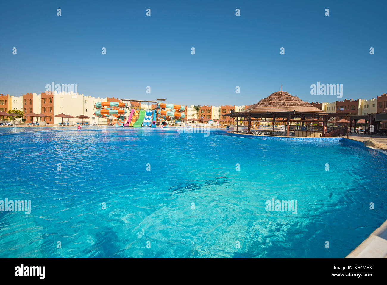 Large swimming pool with bar and aqua park water slides at a luxury ...