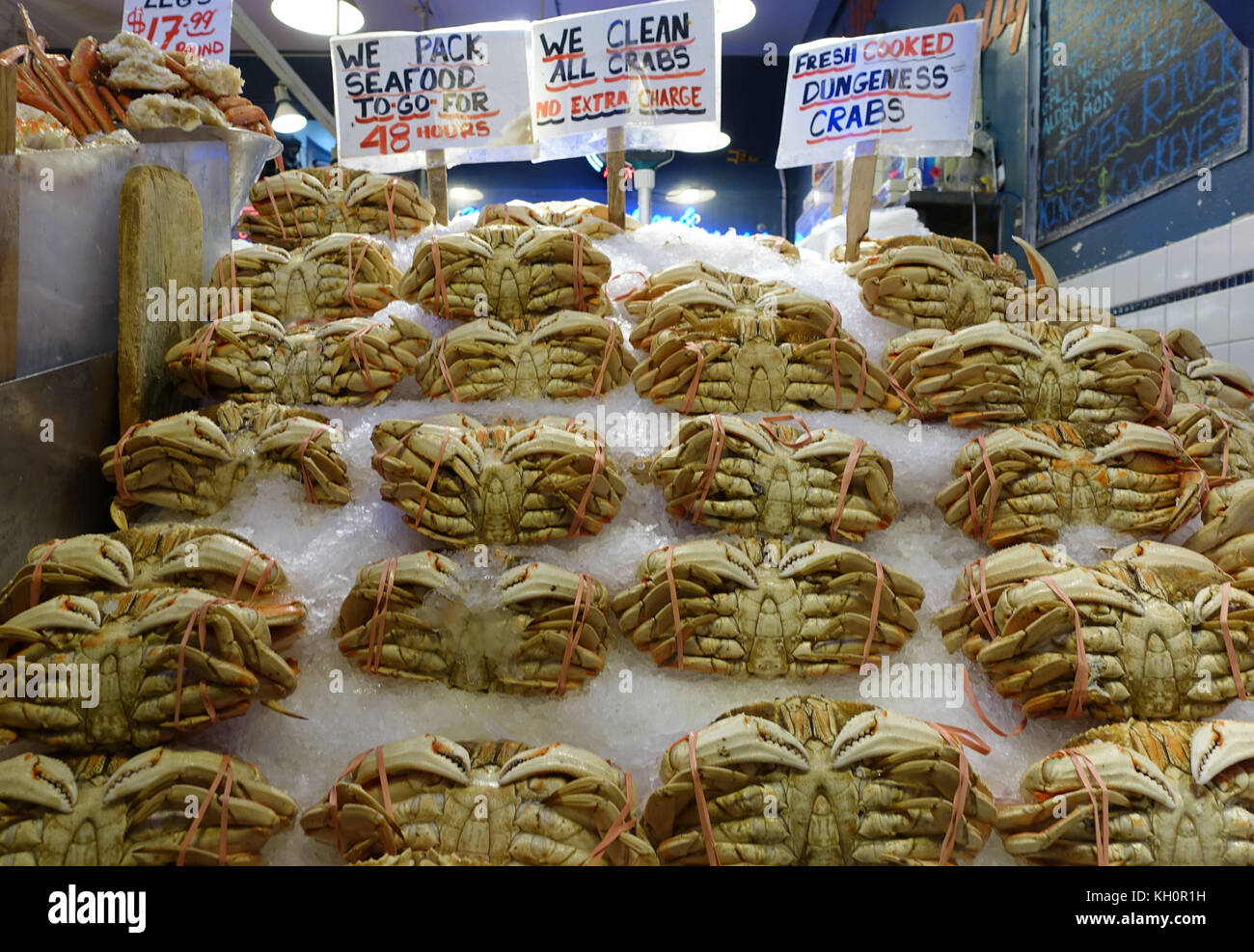 A fish stand sells Dungeness crabs at the Pike Place Market in Seattle ...
