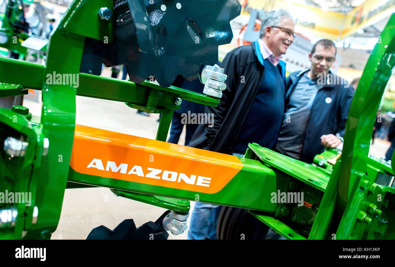 Visitors watching a plow at the stand of the Amazone company in the ...