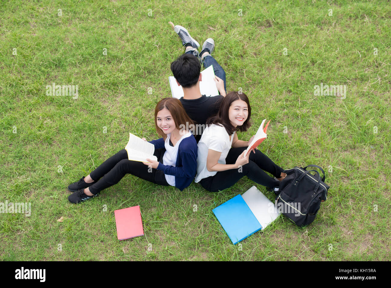 Top view of group of Asian students sitting together at park ...