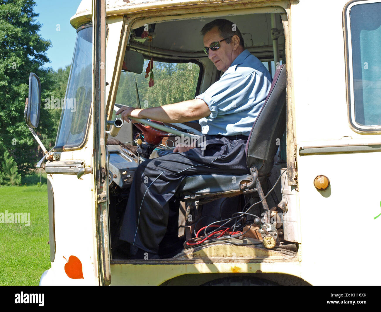 Senior man driving old vintage russian bus Stock Photo - Alamy