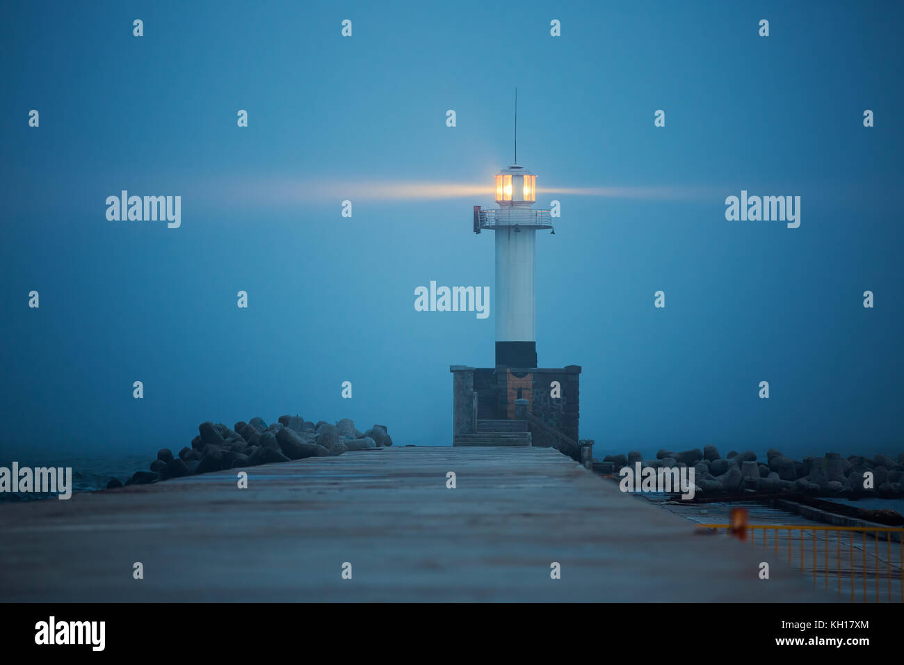 Lighthouse in dense fog and mist, night scene Stock Photo - Alamy