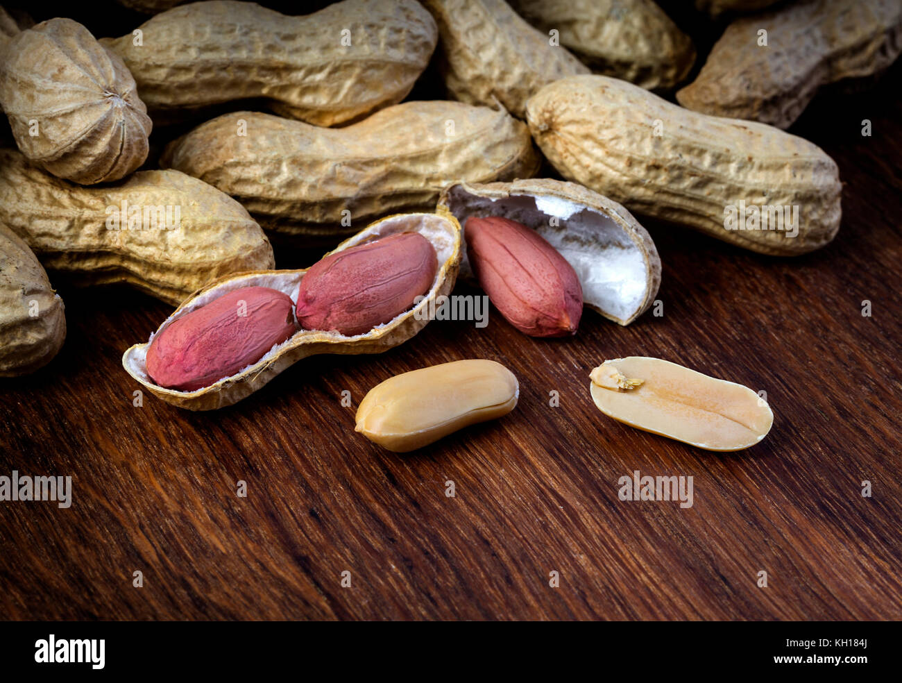 Peanuts in shells on vintage wooden background Stock Photo - Alamy