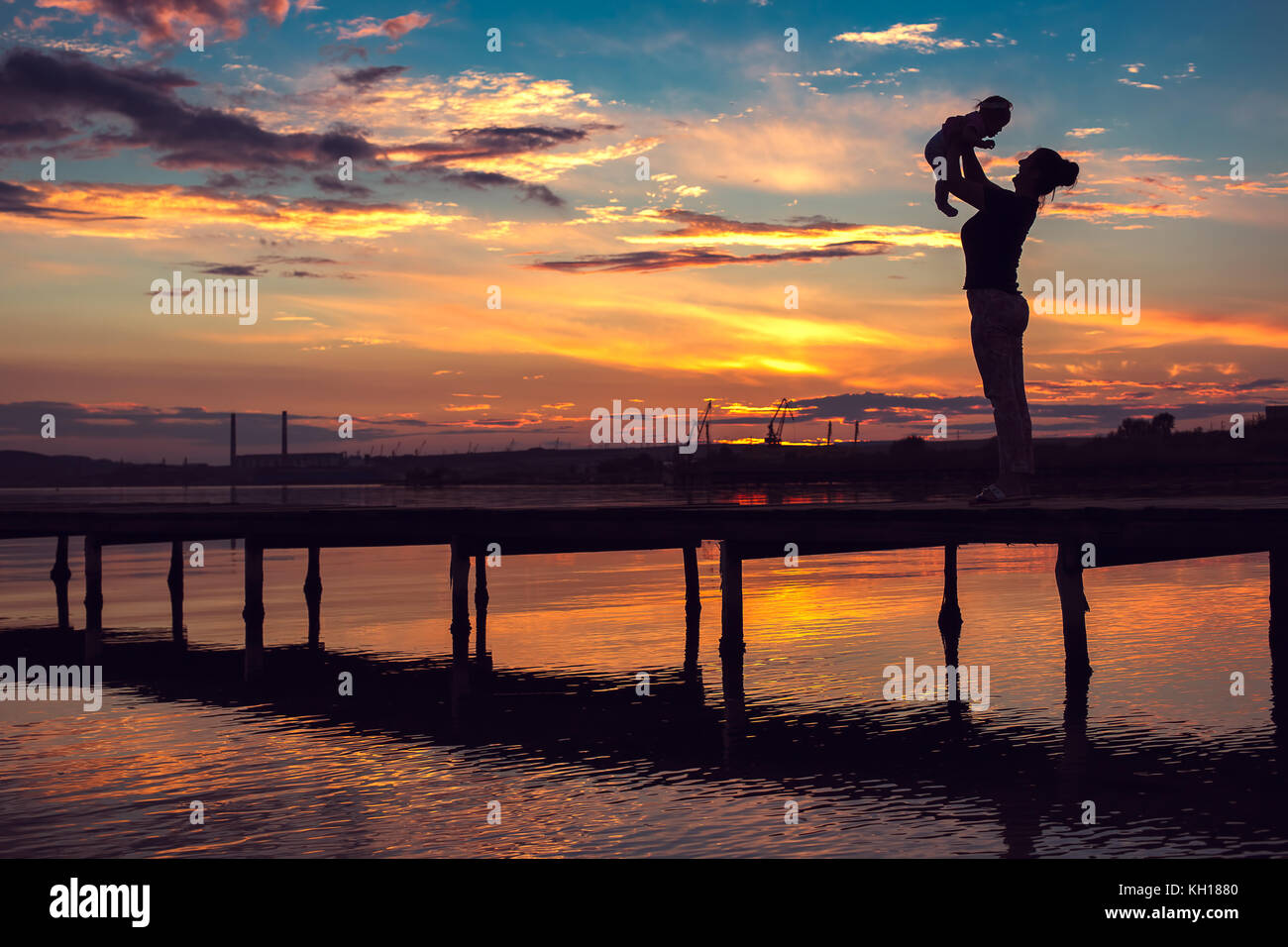 Mother and little baby having fun at sunset Stock Photo - Alamy