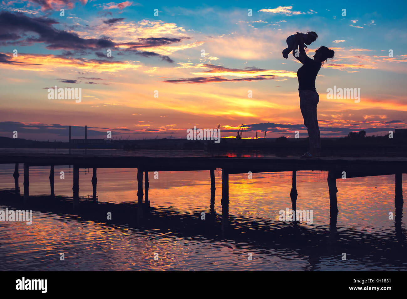 Mother and little baby having fun at sunset Stock Photo - Alamy