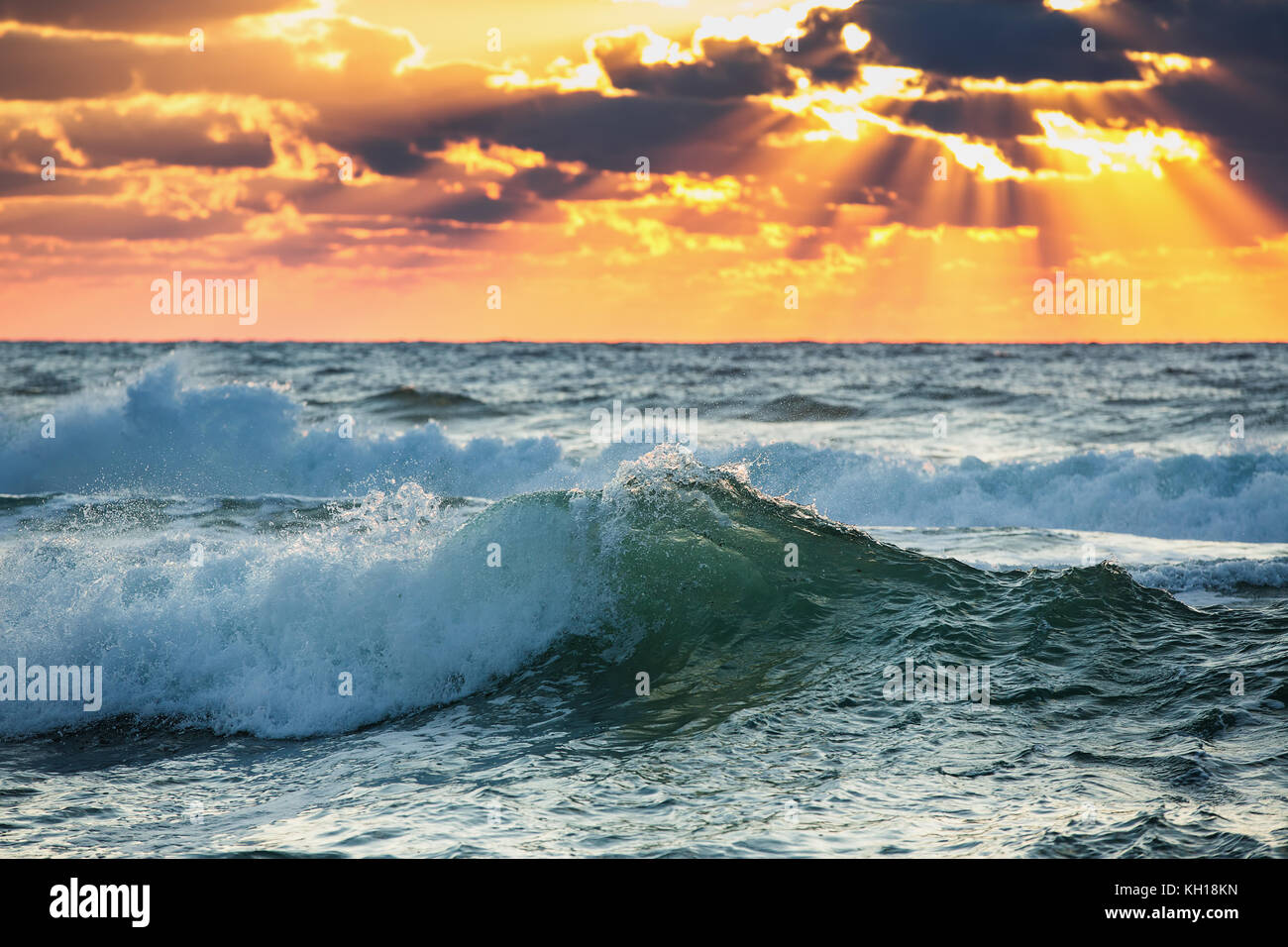Beautiful green sunrise wave Stock Photo - Alamy