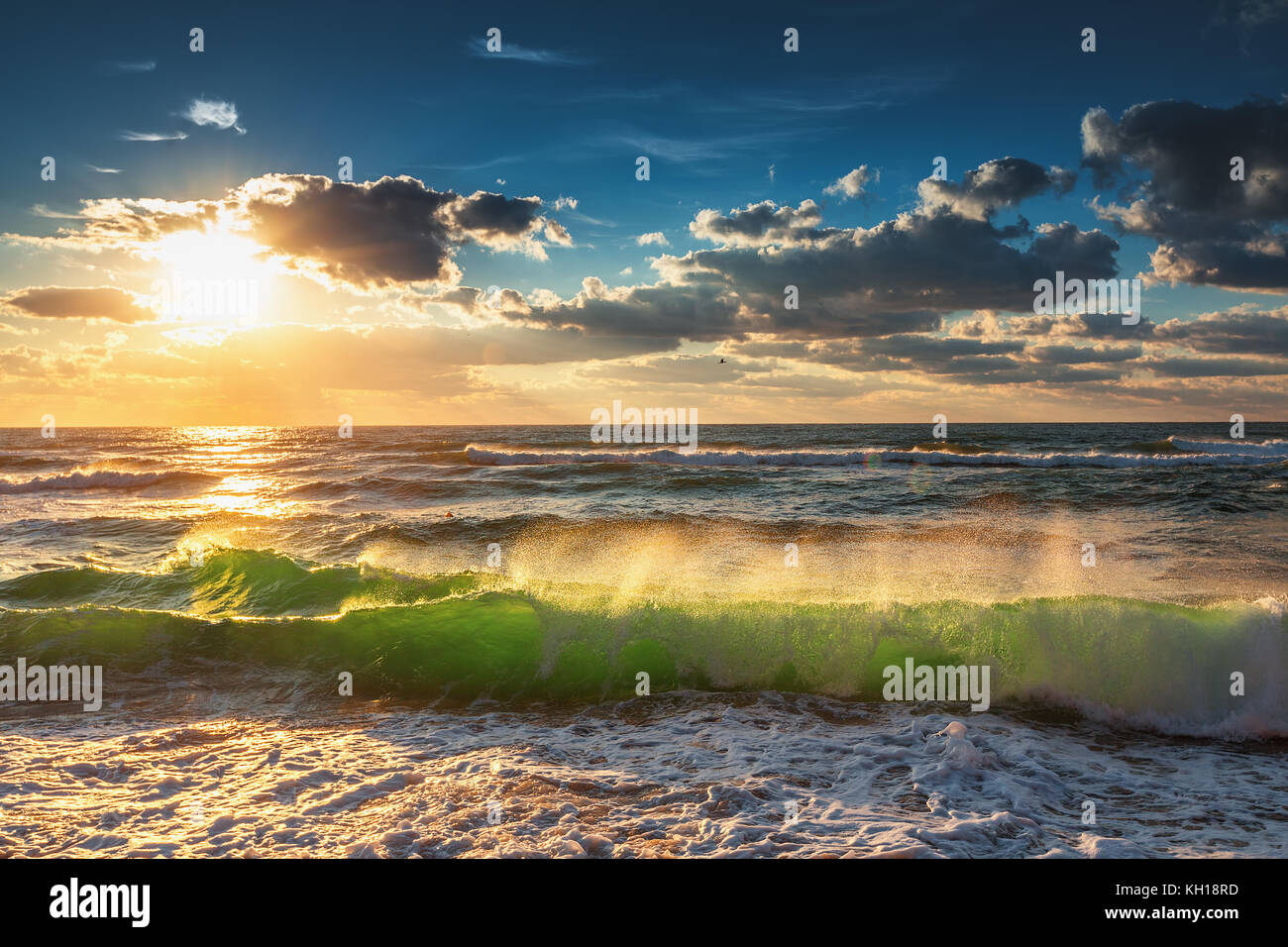Beautiful green sunrise wave Stock Photo - Alamy