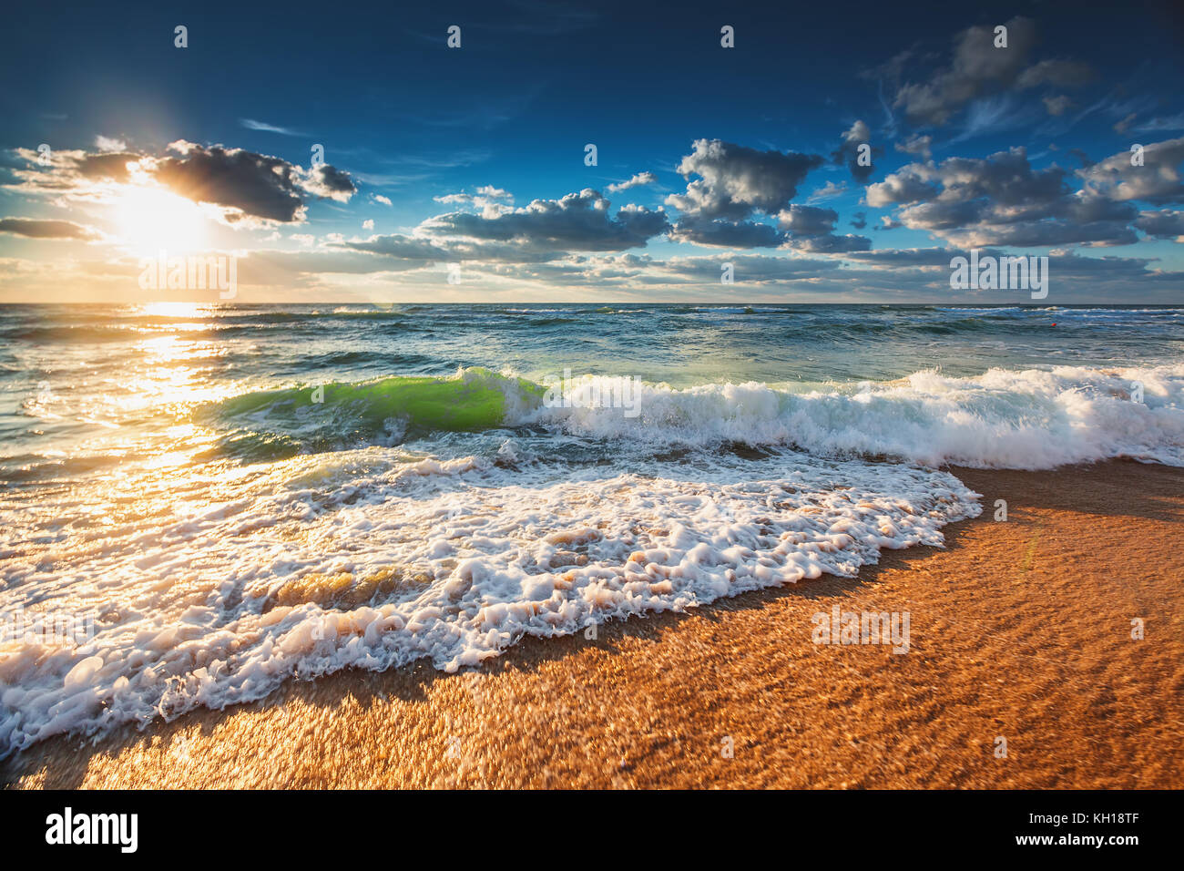 Beautiful green sunrise wave Stock Photo - Alamy