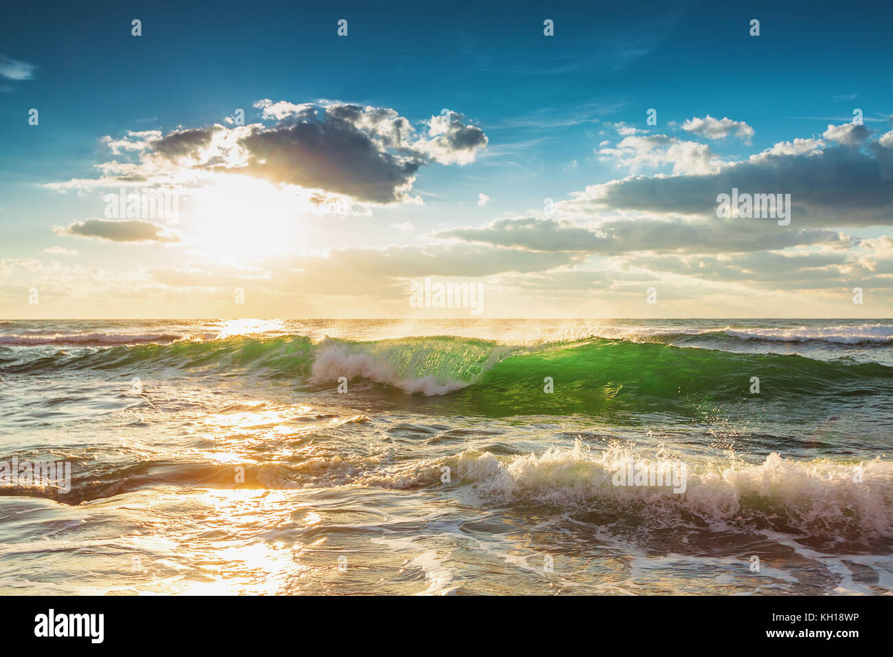 Beautiful green sunrise wave Stock Photo - Alamy