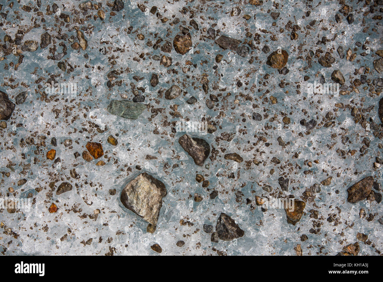 Detailed top view of ice and rocks: the surface of an arctic glacier ...