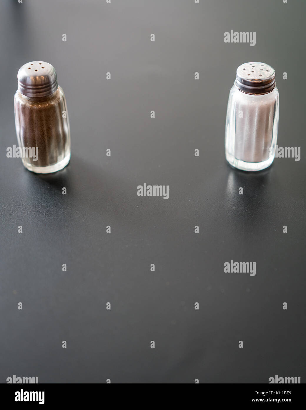 Salt and Pepper on Dark Grey Surface, with copy space Stock Photo - Alamy