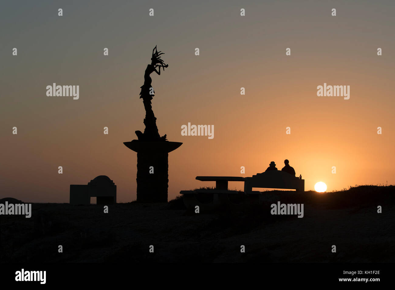 Mermaid Playing the Flute at Sunset and People on Bench Stock Photo - Alamy