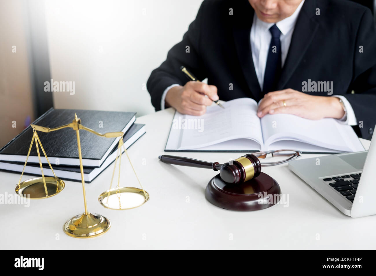 lawyer hand writes the document in court (justice, law) with sounding ...