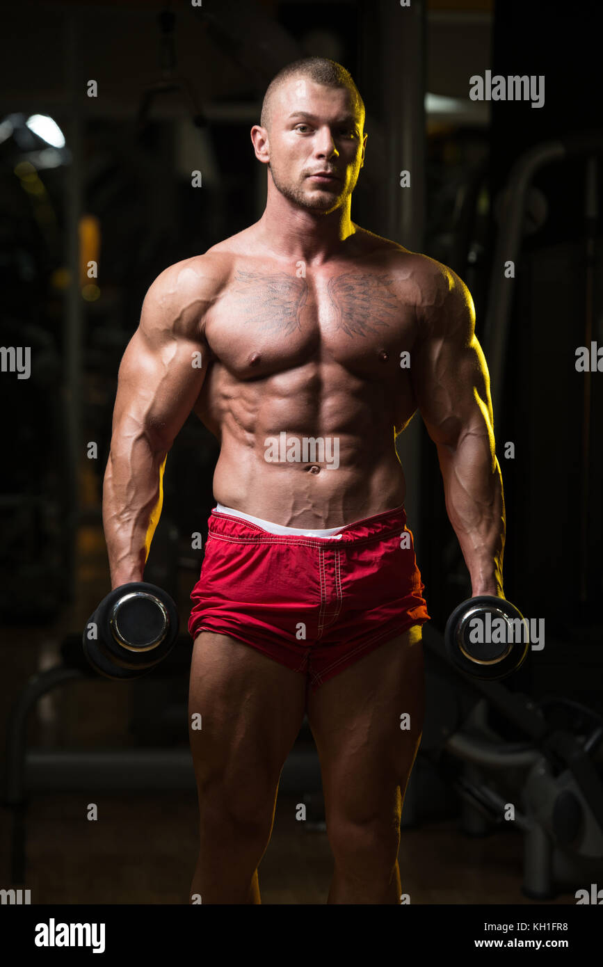 Athlete Working Out Biceps In A Gym - Dumbbell Concentration Curls ...