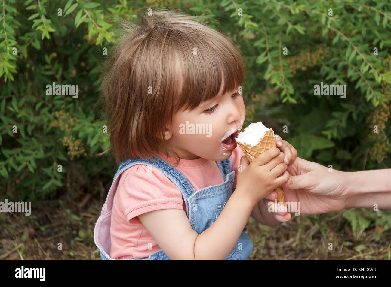 Photo of cute girl are eating icecream in summer time Stock Photo - Alamy