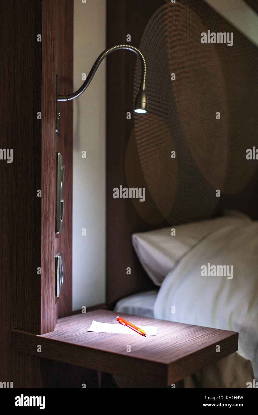 Note with pen beside the pillow on bed Stock Photo - Alamy