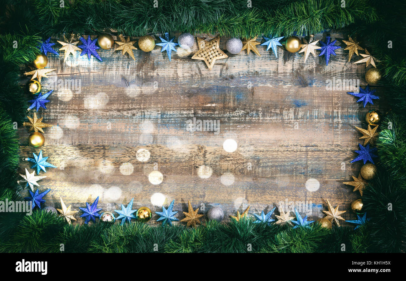 Christmas ornaments and green garland on a wooden board, copy space ...