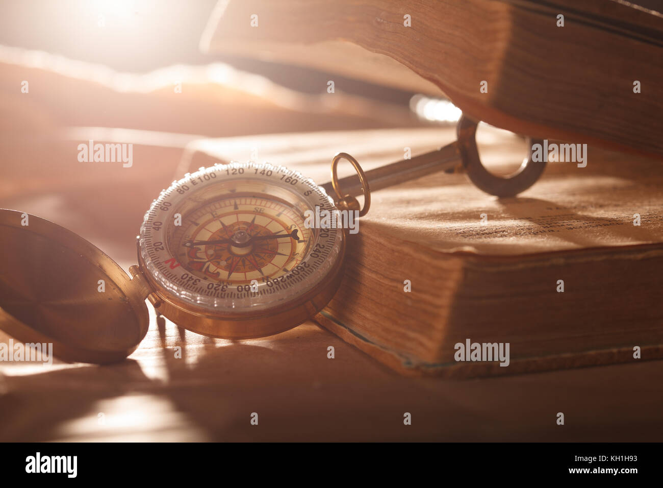 Old vintage retro compass with a book. Travel concept background Stock ...