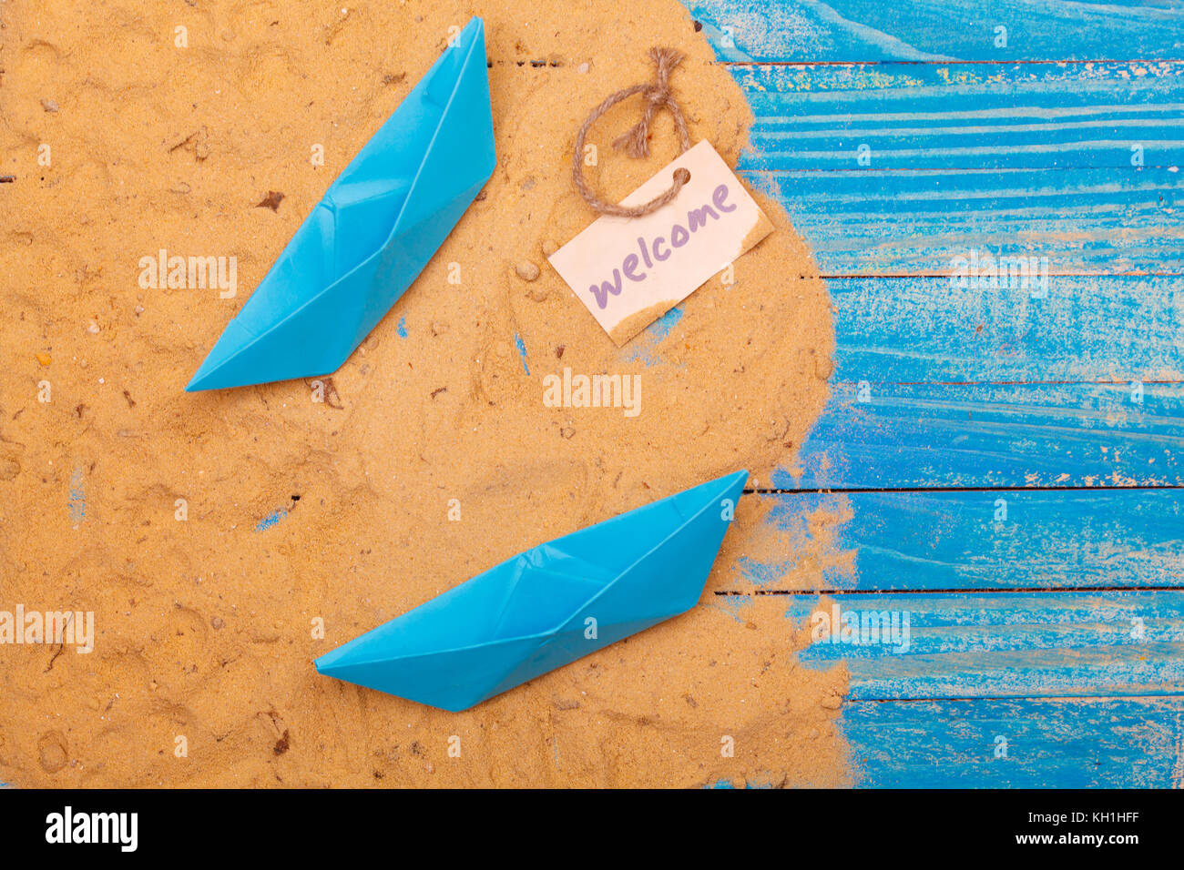 Blue paper boats on beach sand outdoors. Travel concept Stock Photo - Alamy