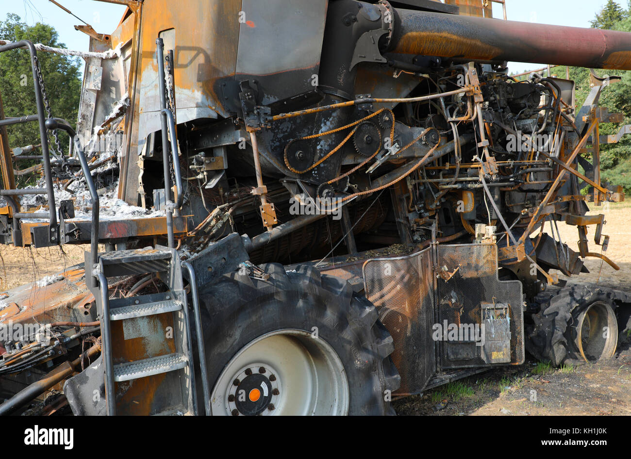 Closeup of a burnt out combine harvester in field Stock Photo - Alamy