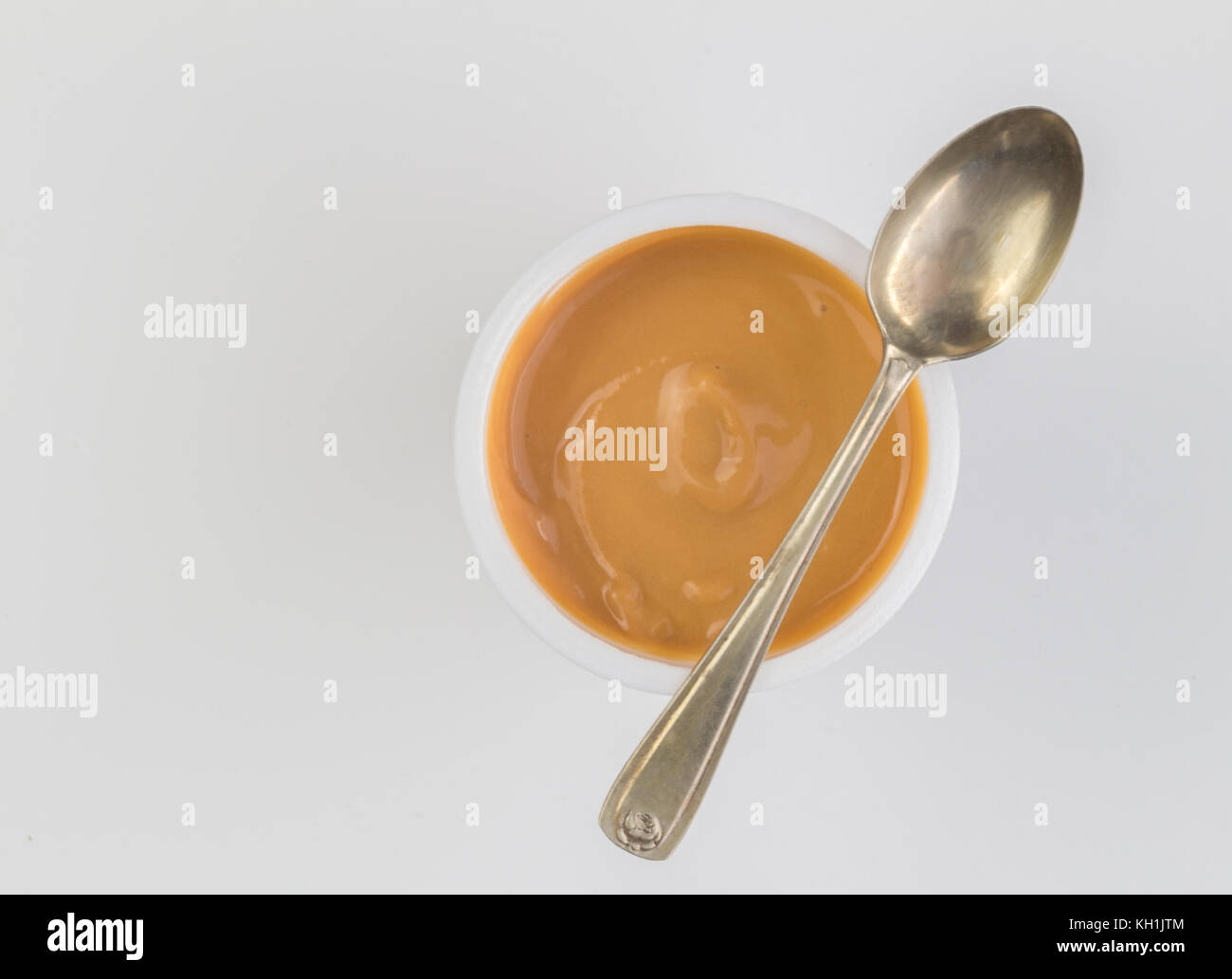 Yogurt background top view shot of caramel flavoured yoghurt in plastic ...