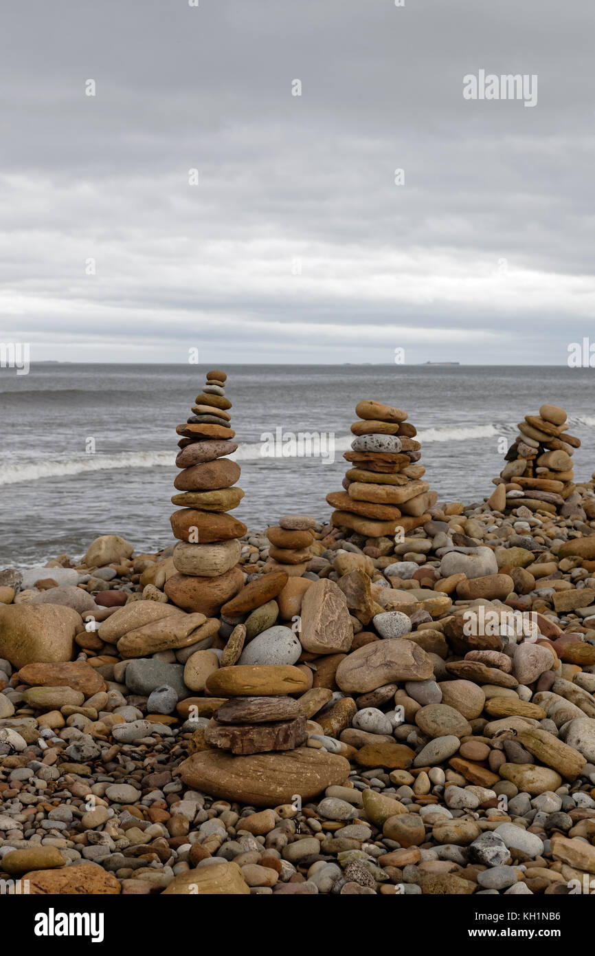 Man made stacks of stone / cairns - lining the east beach of Holy ...