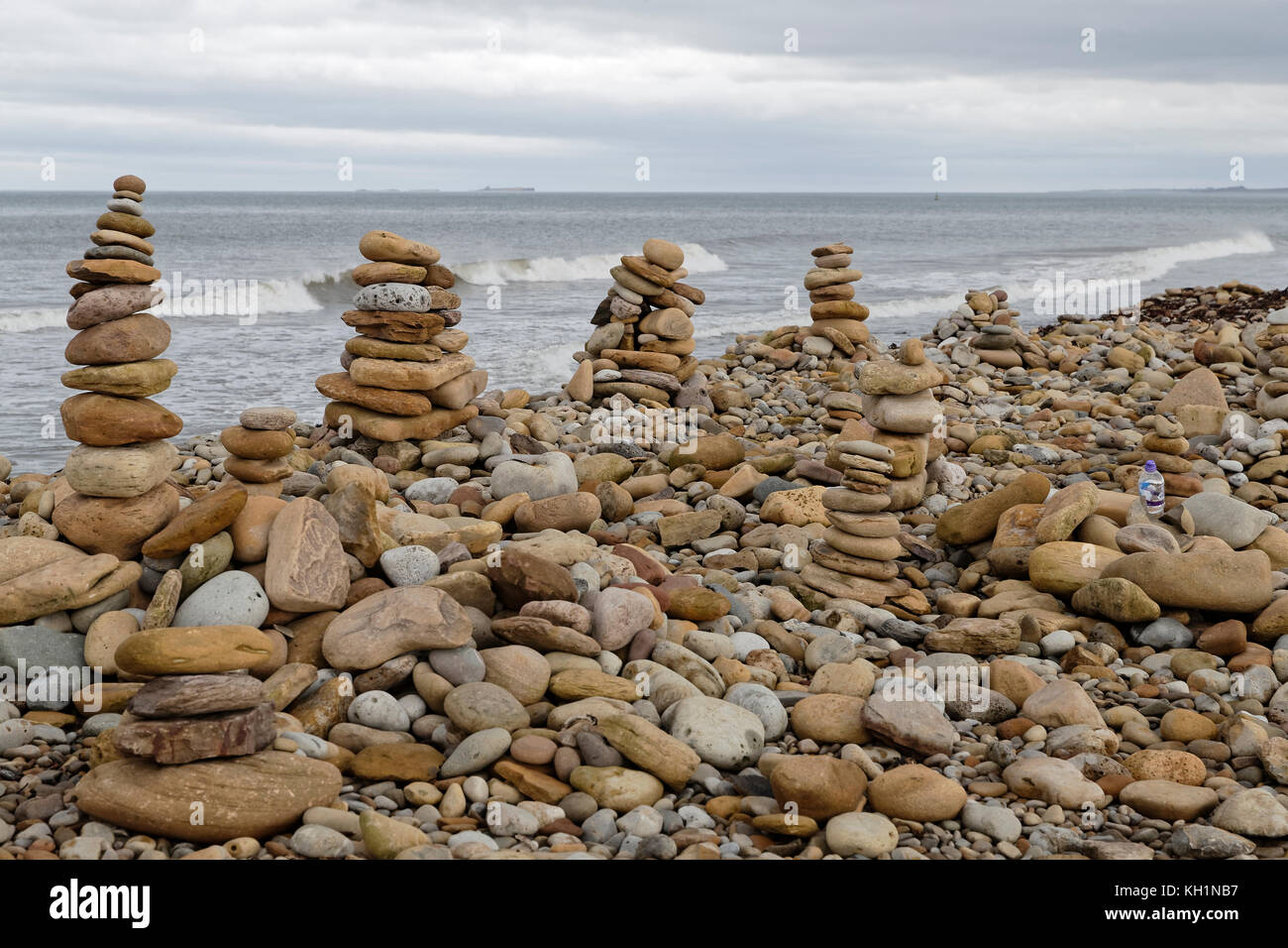 Man made stacks of stone / cairns - lining the east beach of Holy ...