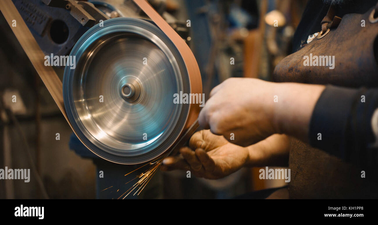 Craftsman uses a belt sander in a mechanical workshop Stock Photo - Alamy